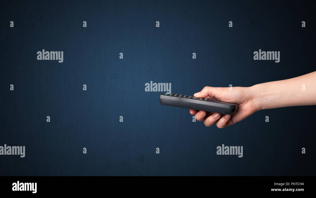 Hand with remote control Stock Photo - Alamy