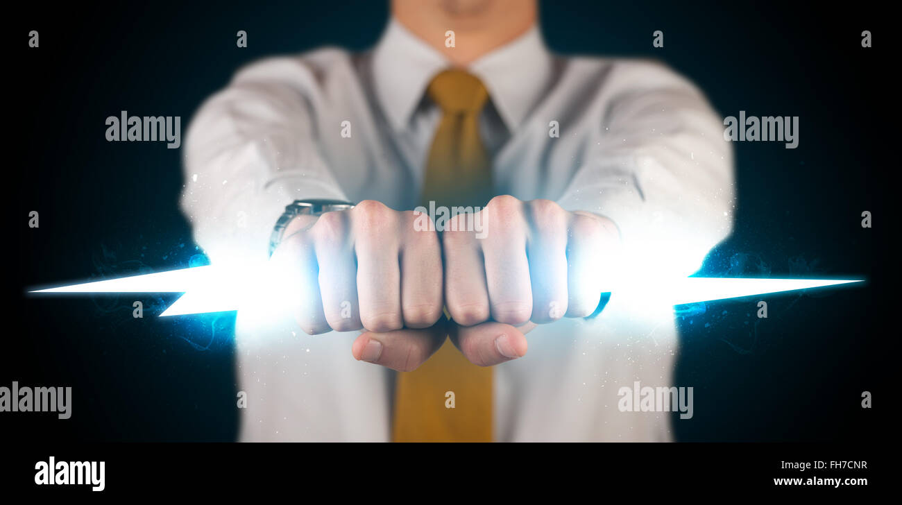 Business man holding glowing lightning bolt in his hands Stock Photo ...