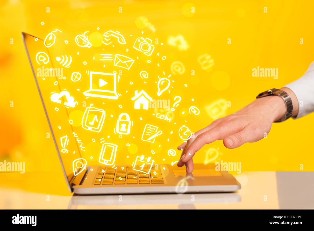 Hand writing on notebook computer with media icons and symbols Stock ...