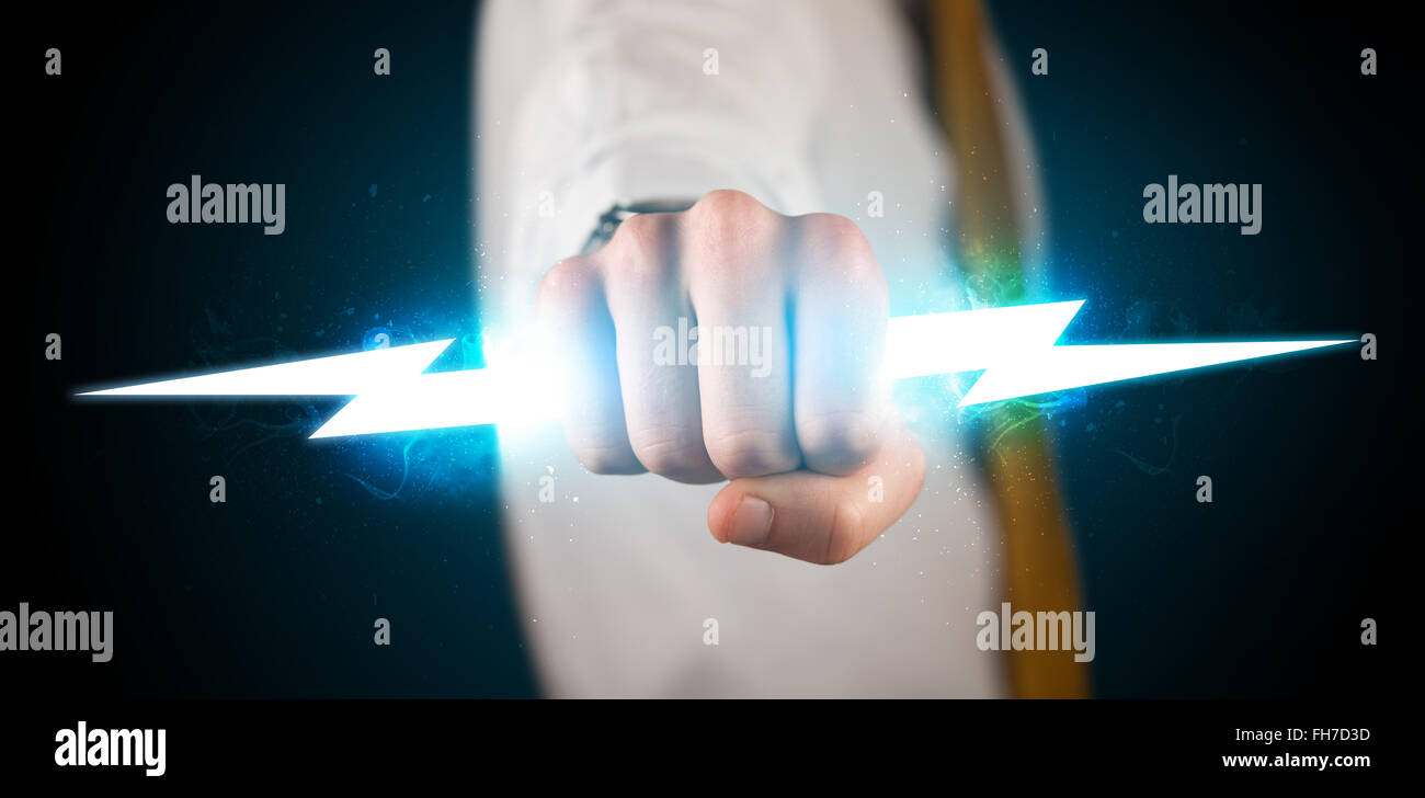 Business man holding glowing lightning bolt in his hands Stock Photo ...