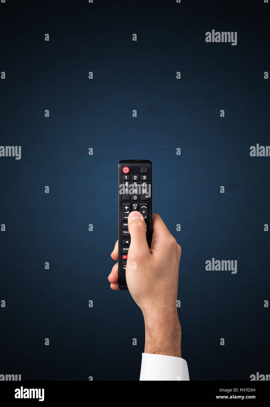 Hand with remote control Stock Photo - Alamy