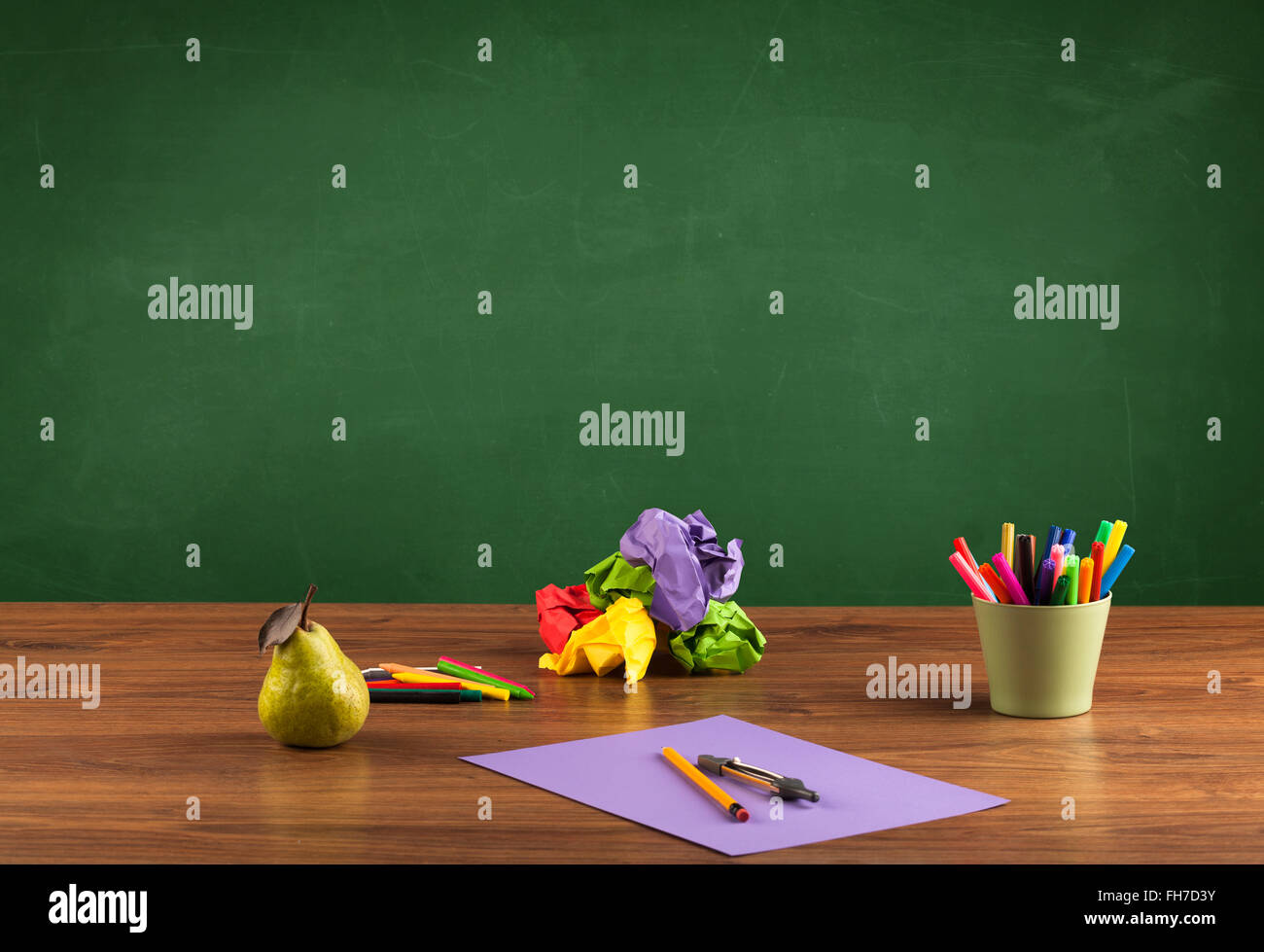 School items on desk with empty chalkboard Stock Photo - Alamy