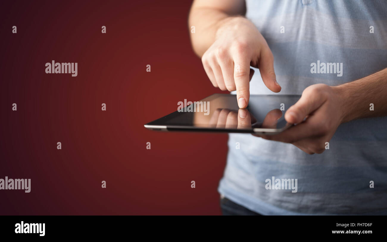 Close up of hand holding digital touchpad tablet device Stock Photo - Alamy