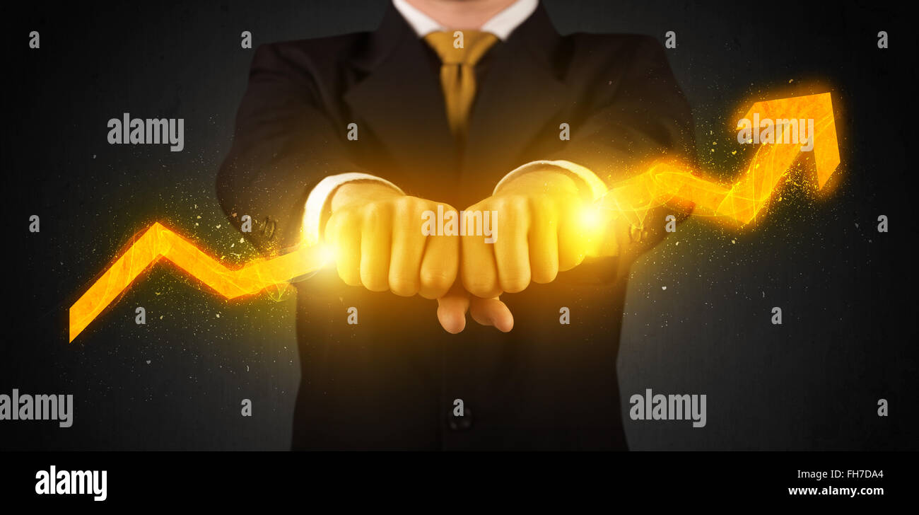 Business person holding a hot glowing upright arrow Stock Photo - Alamy