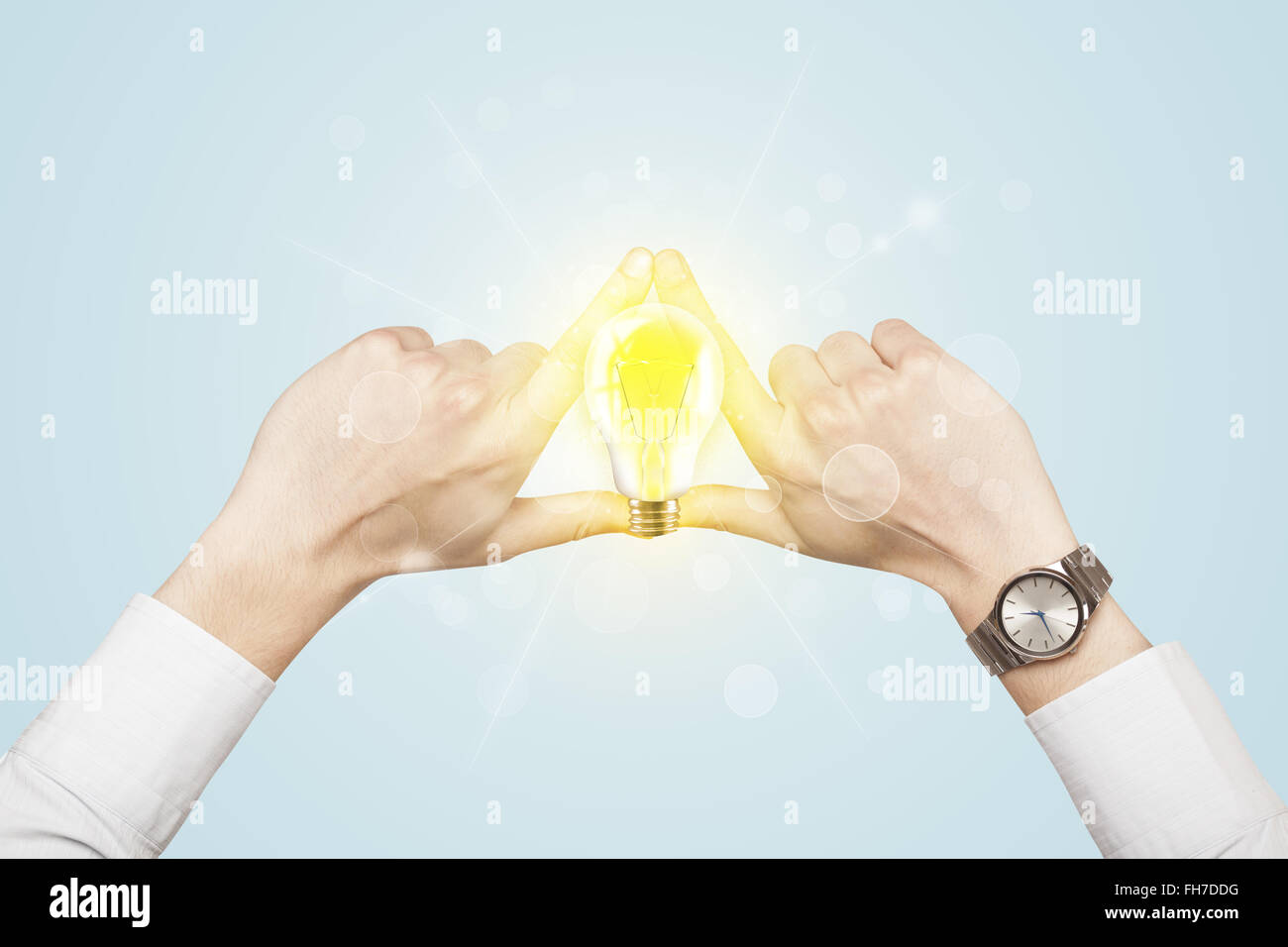Hands creating a form with light bulb Stock Photo - Alamy