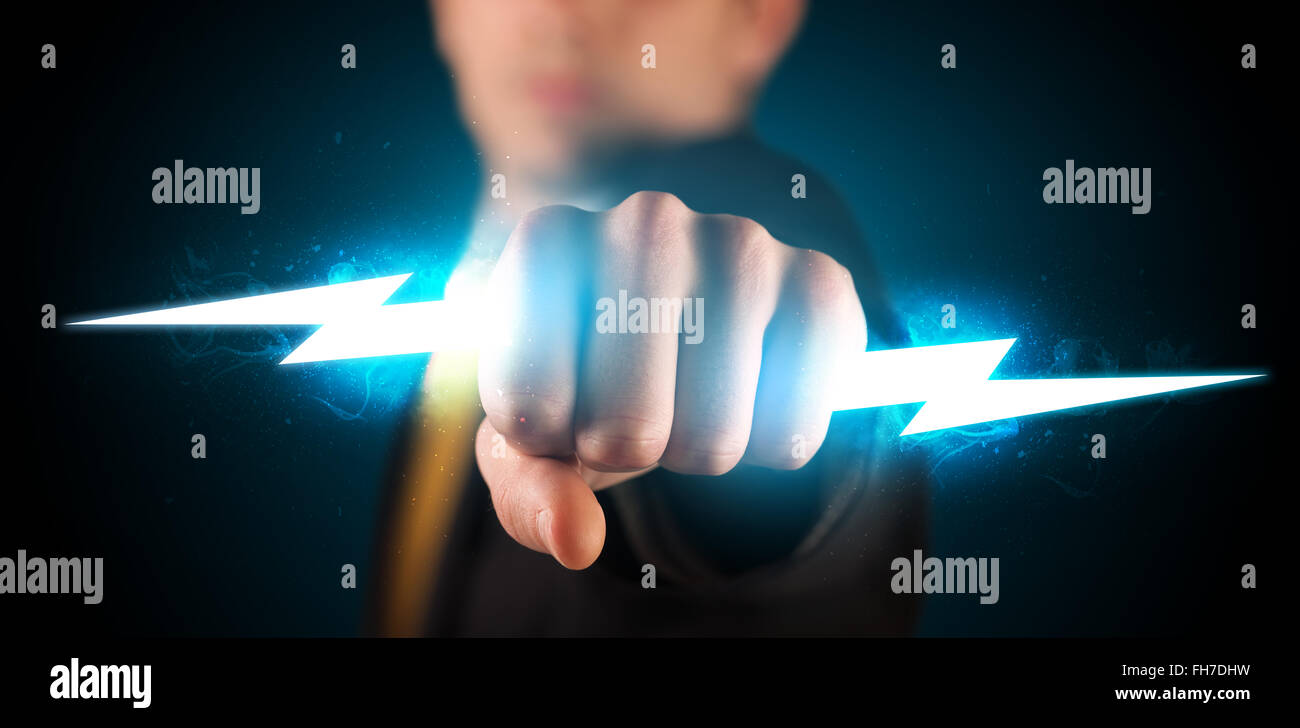 Business man holding glowing lightning bolt in his hands Stock Photo ...
