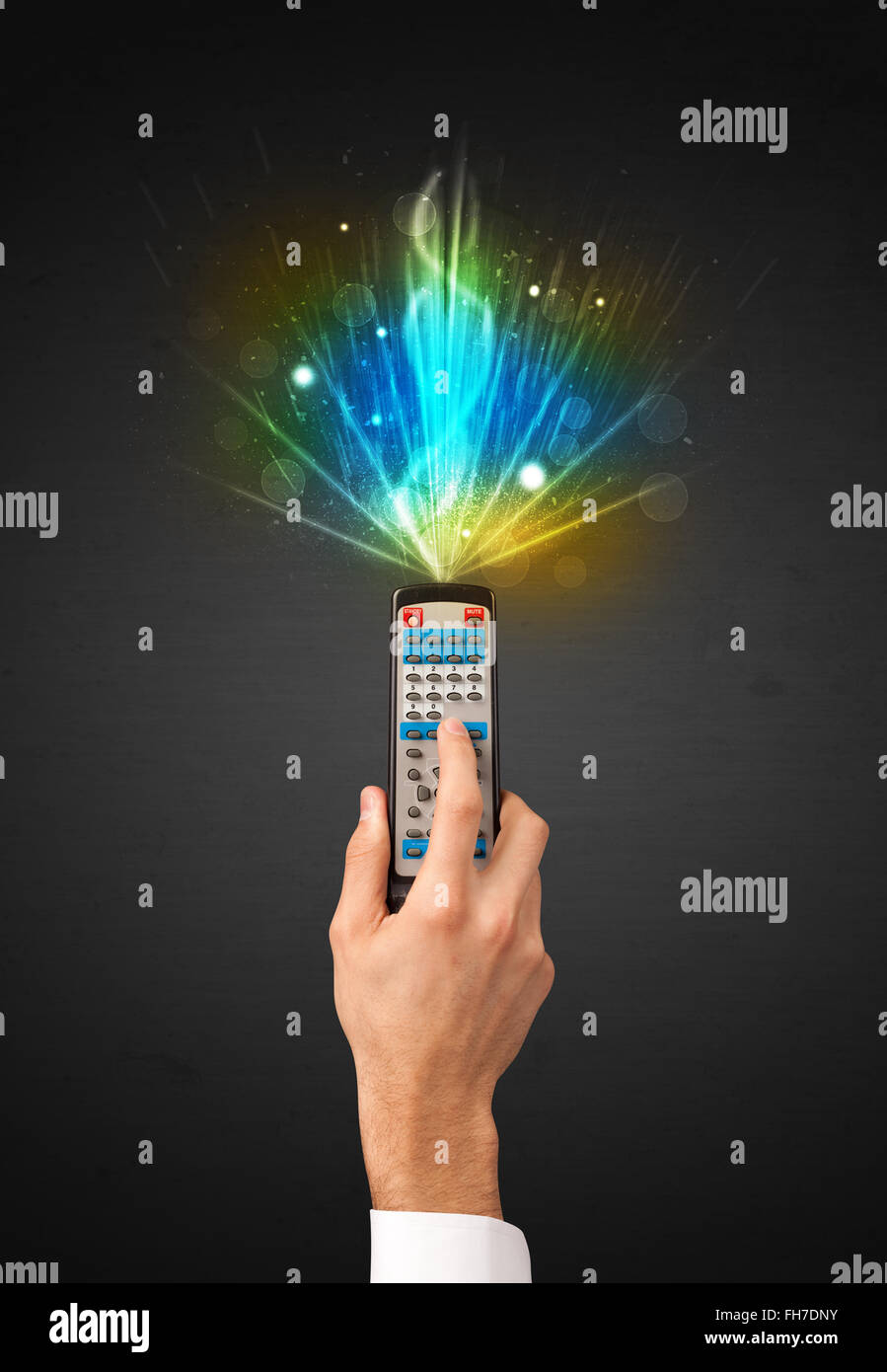 Hand with remote control and explosive signal Stock Photo - Alamy