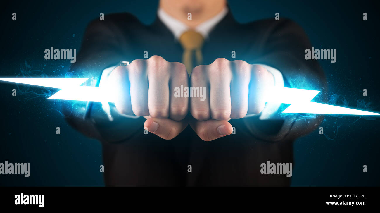 Business man holding glowing lightning bolt in his hands Stock Photo ...