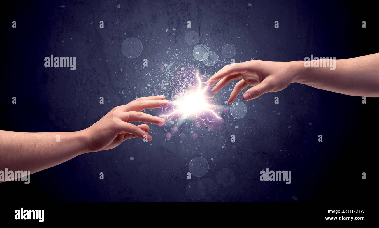 Hands reaching to light a spark Stock Photo - Alamy