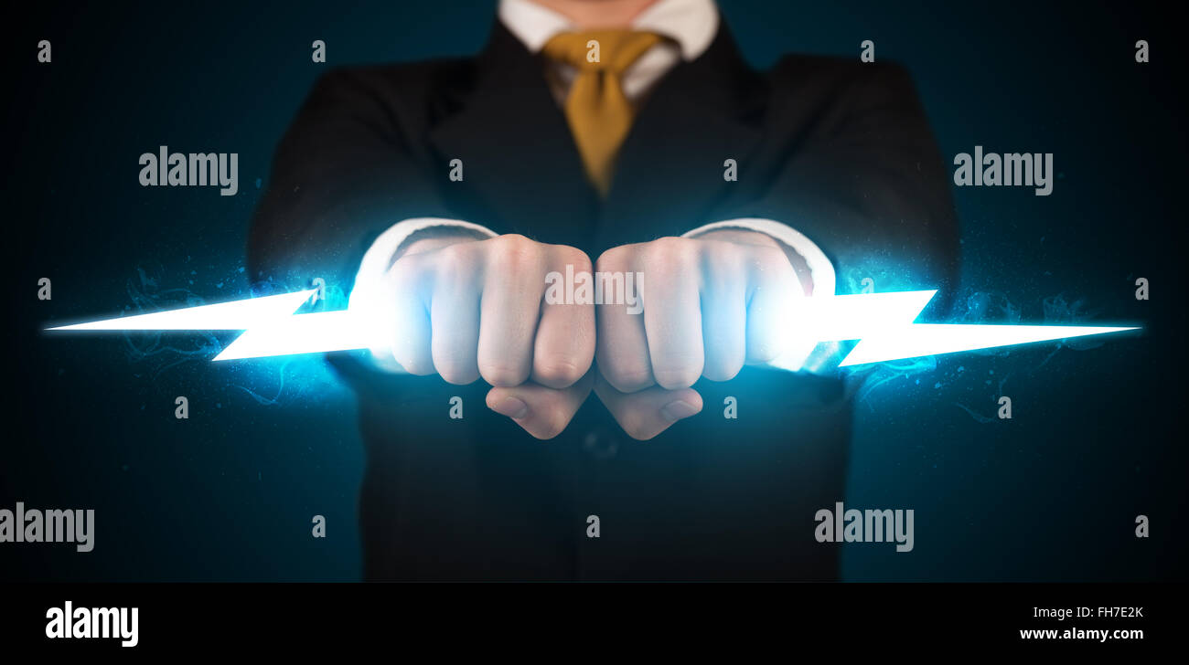 Business man holding glowing lightning bolt in his hands Stock Photo ...