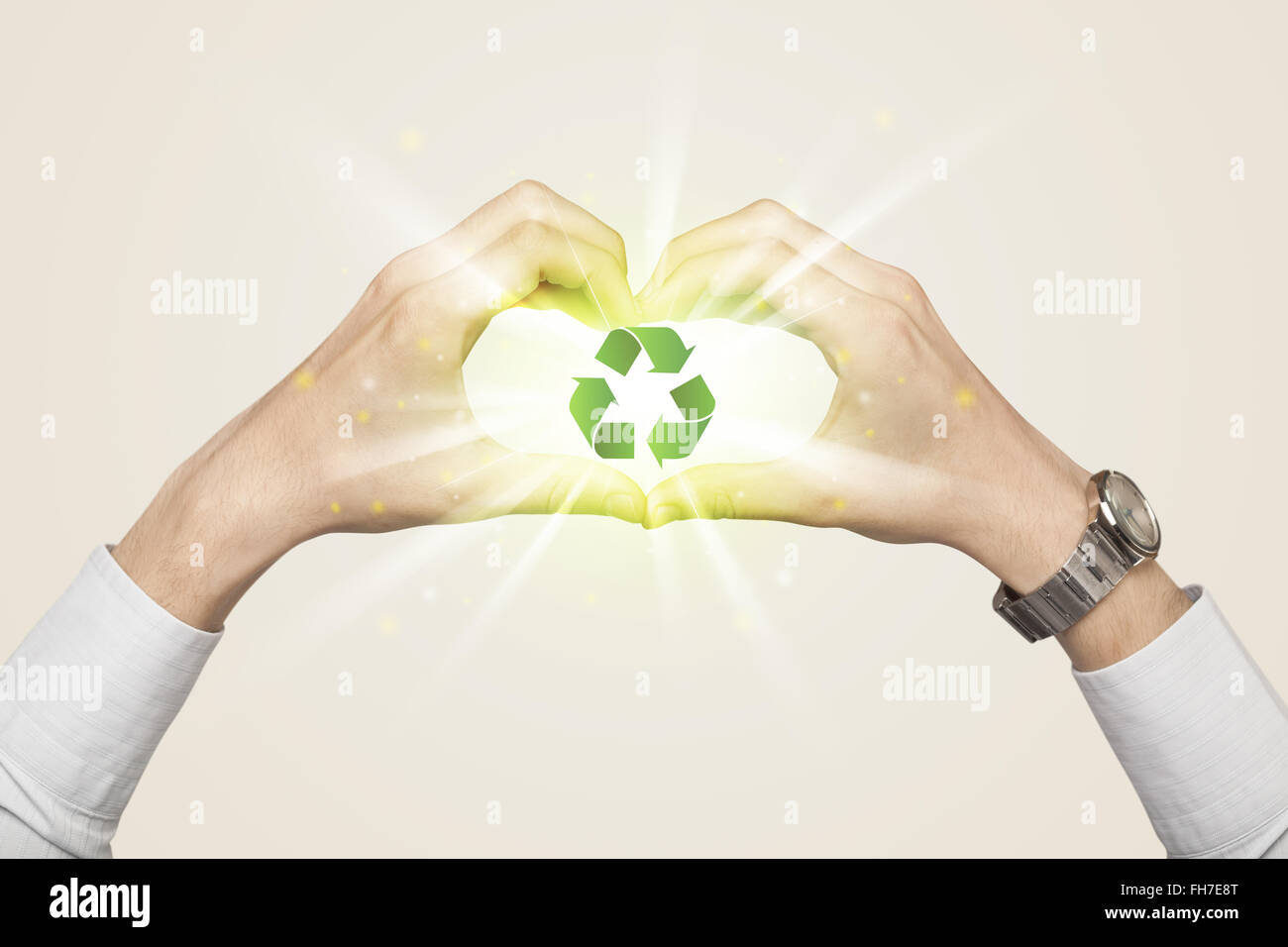 Hands creating a form with recycling sign Stock Photo - Alamy