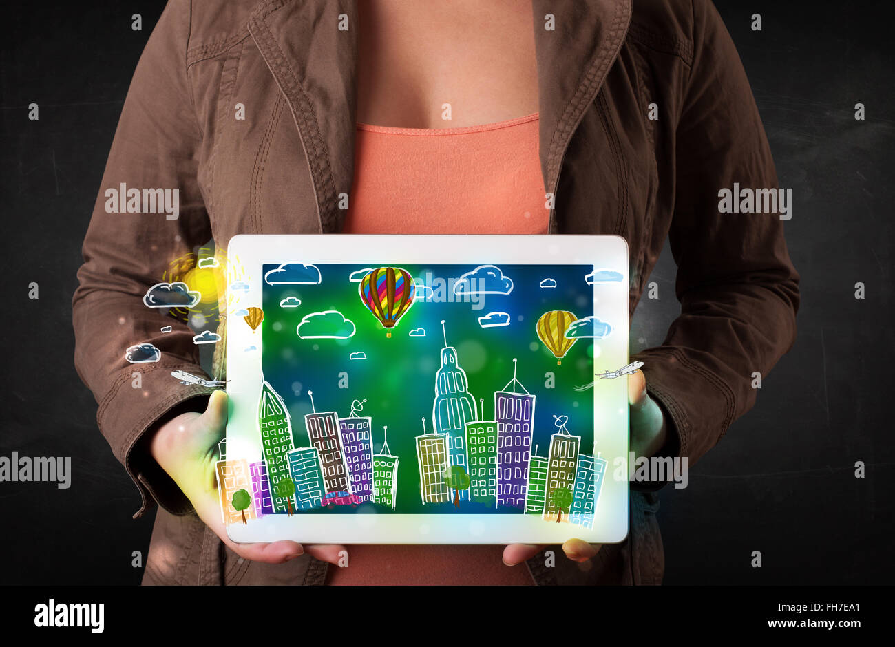 Young person showing tablet with hand drawn cityscape Stock Photo - Alamy