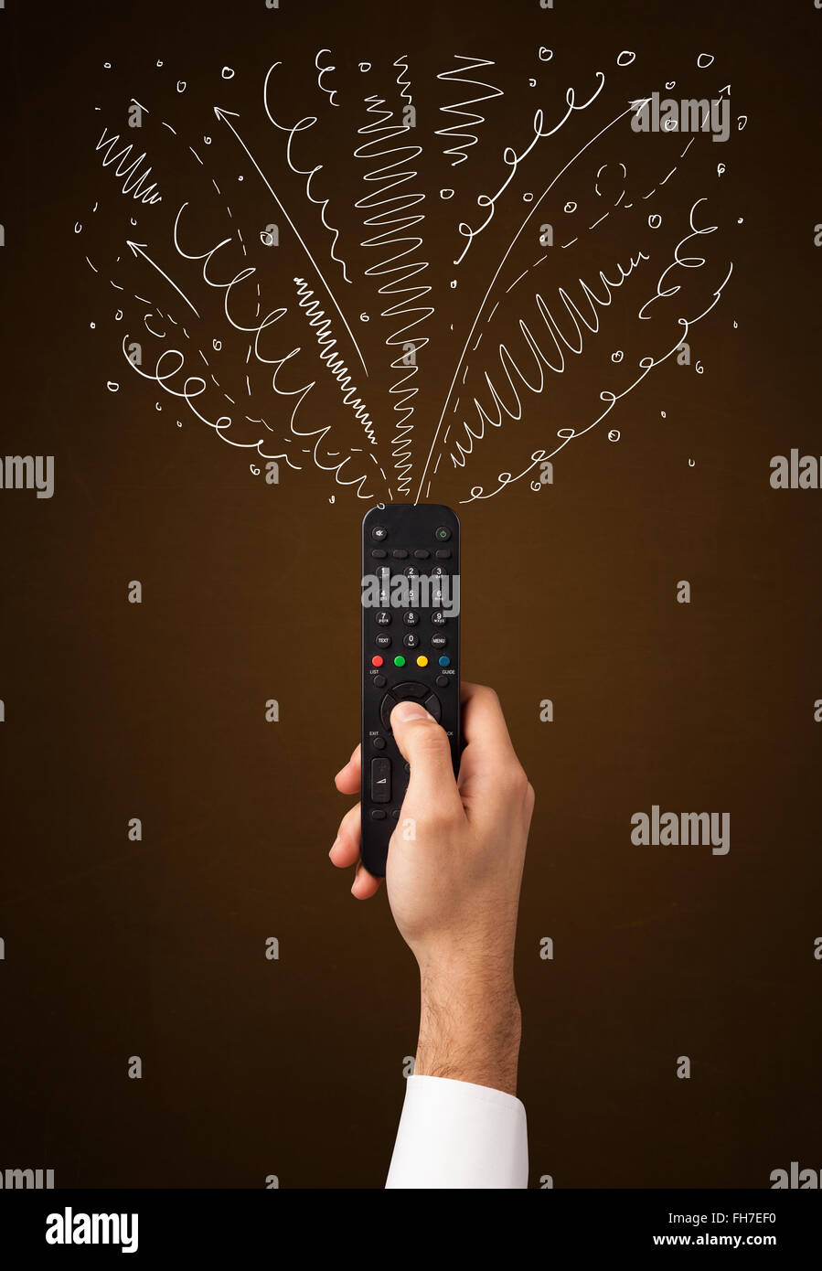Hand with remote control and curly lines Stock Photo - Alamy