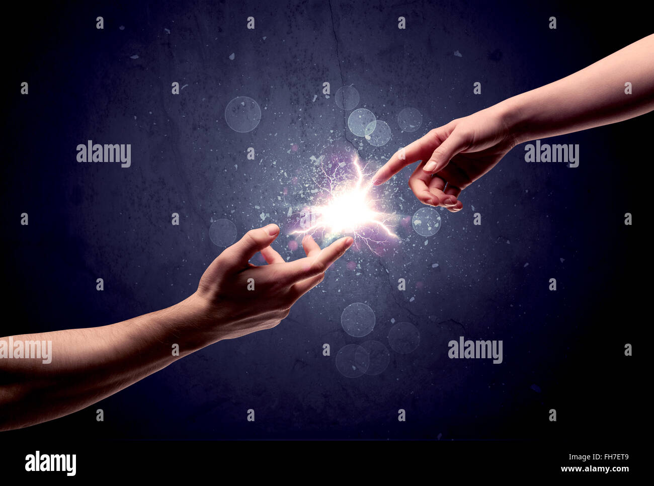 Hands reaching to light a spark Stock Photo - Alamy
