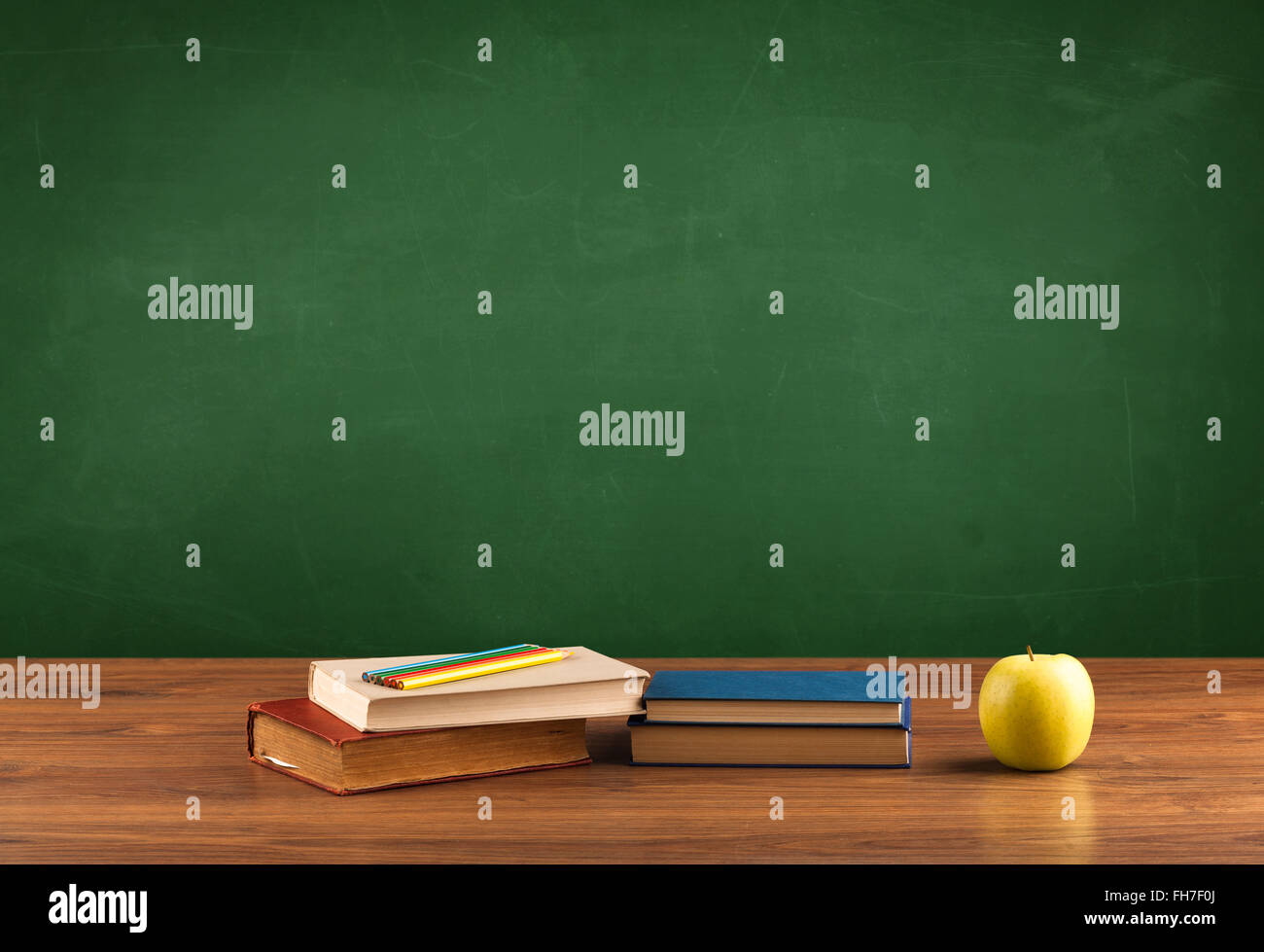 School items on desk with empty chalkboard Stock Photo - Alamy
