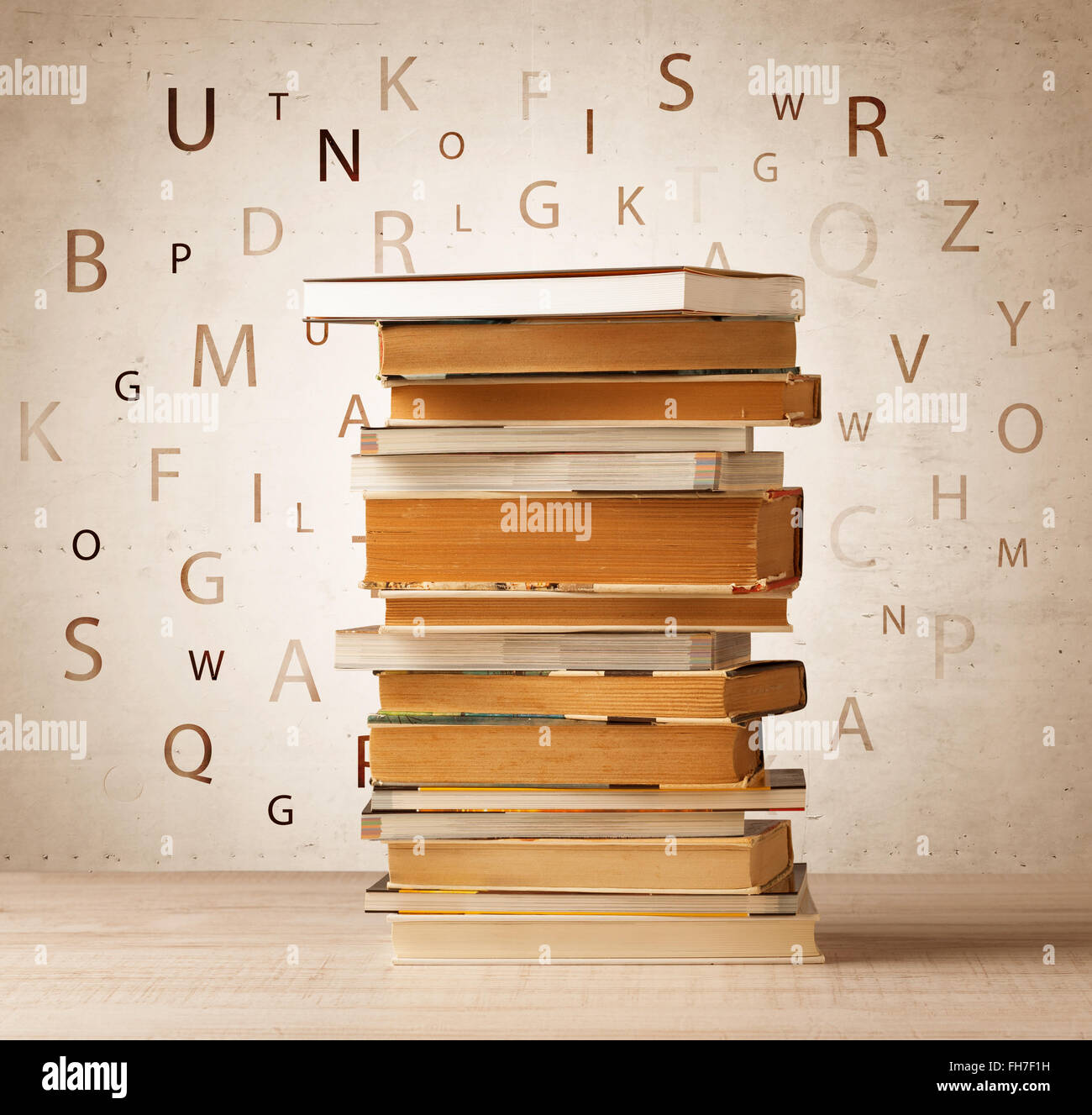 Books with flying letters on vintage background Stock Photo - Alamy
