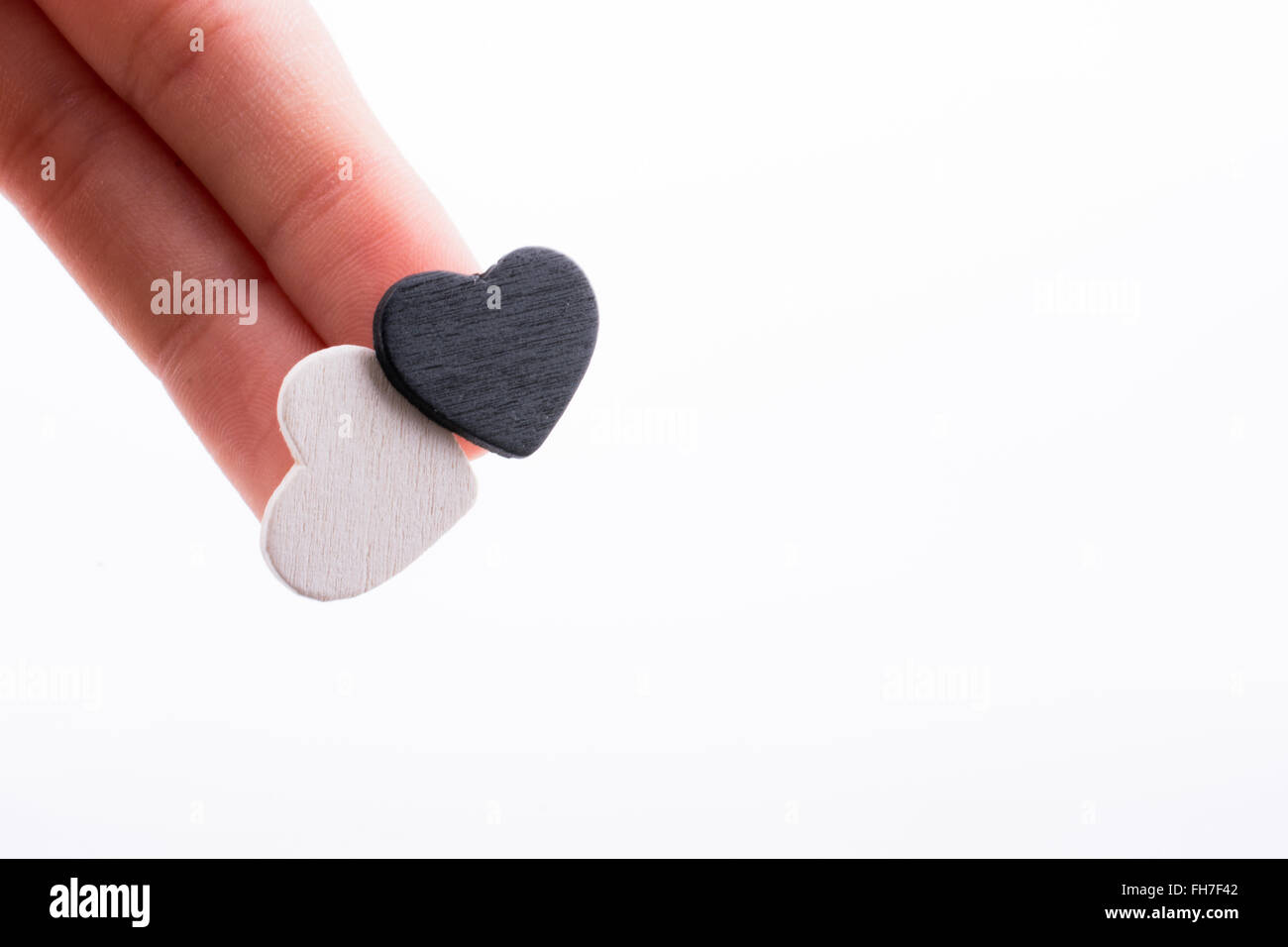 Heart shape objects on fingertips Stock Photo - Alamy