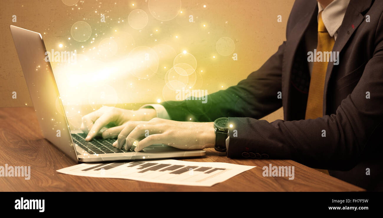 Businessman working fast on laptop Stock Photo - Alamy