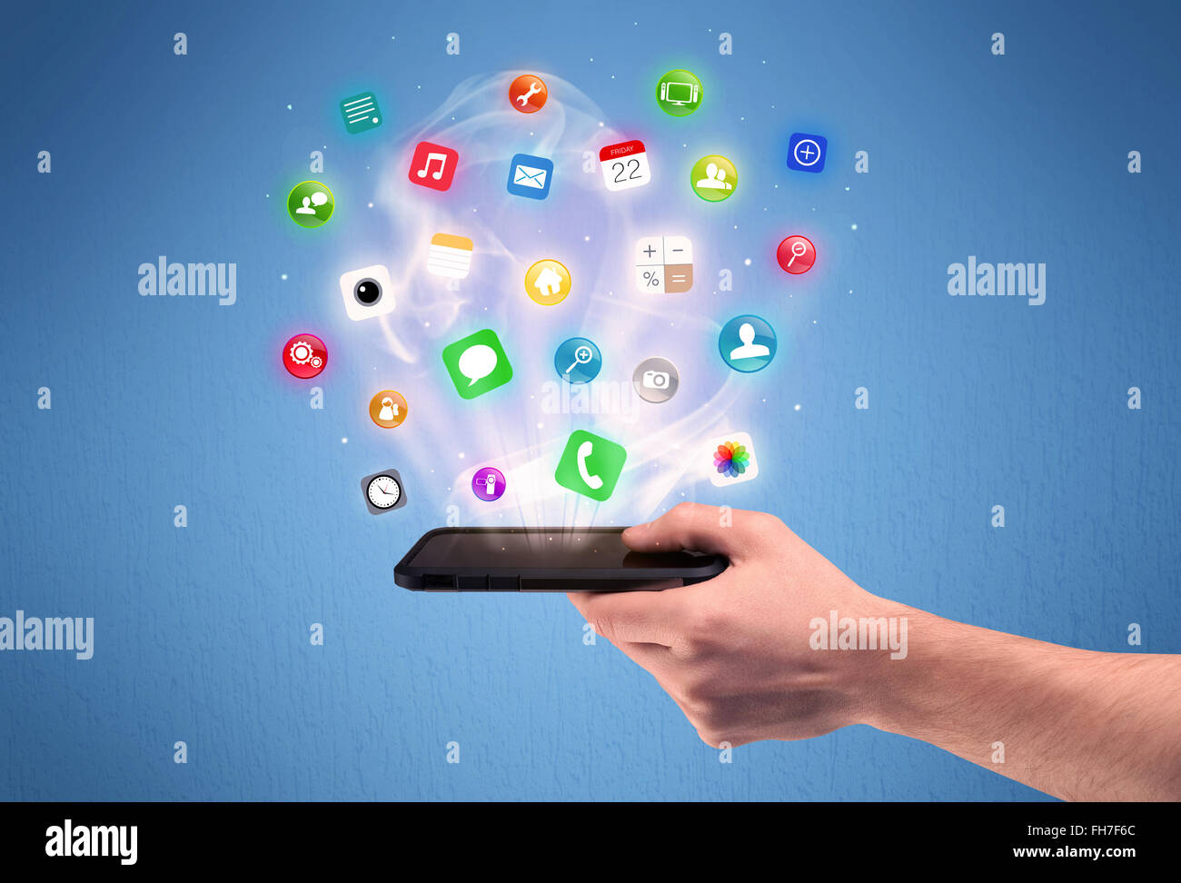 Hand holding tablet phone with app icons Stock Photo - Alamy