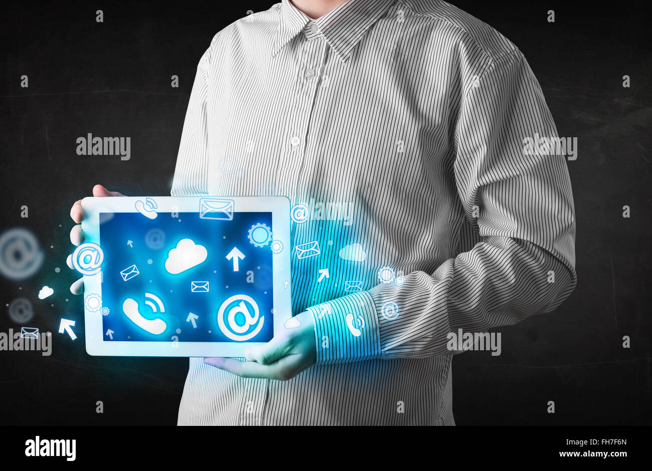 Person holding a tablet with blue technology icons and symbols Stock ...
