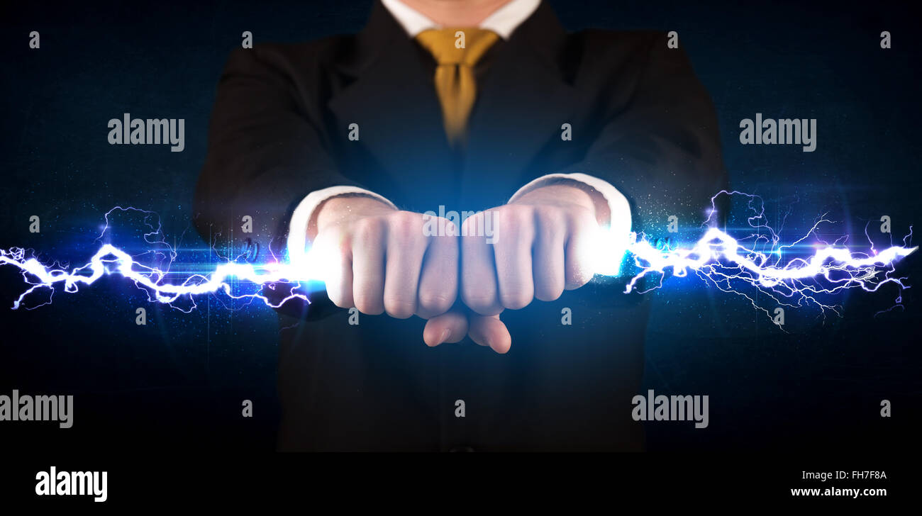Business man holding electricity light bolt in his hands Stock Photo ...