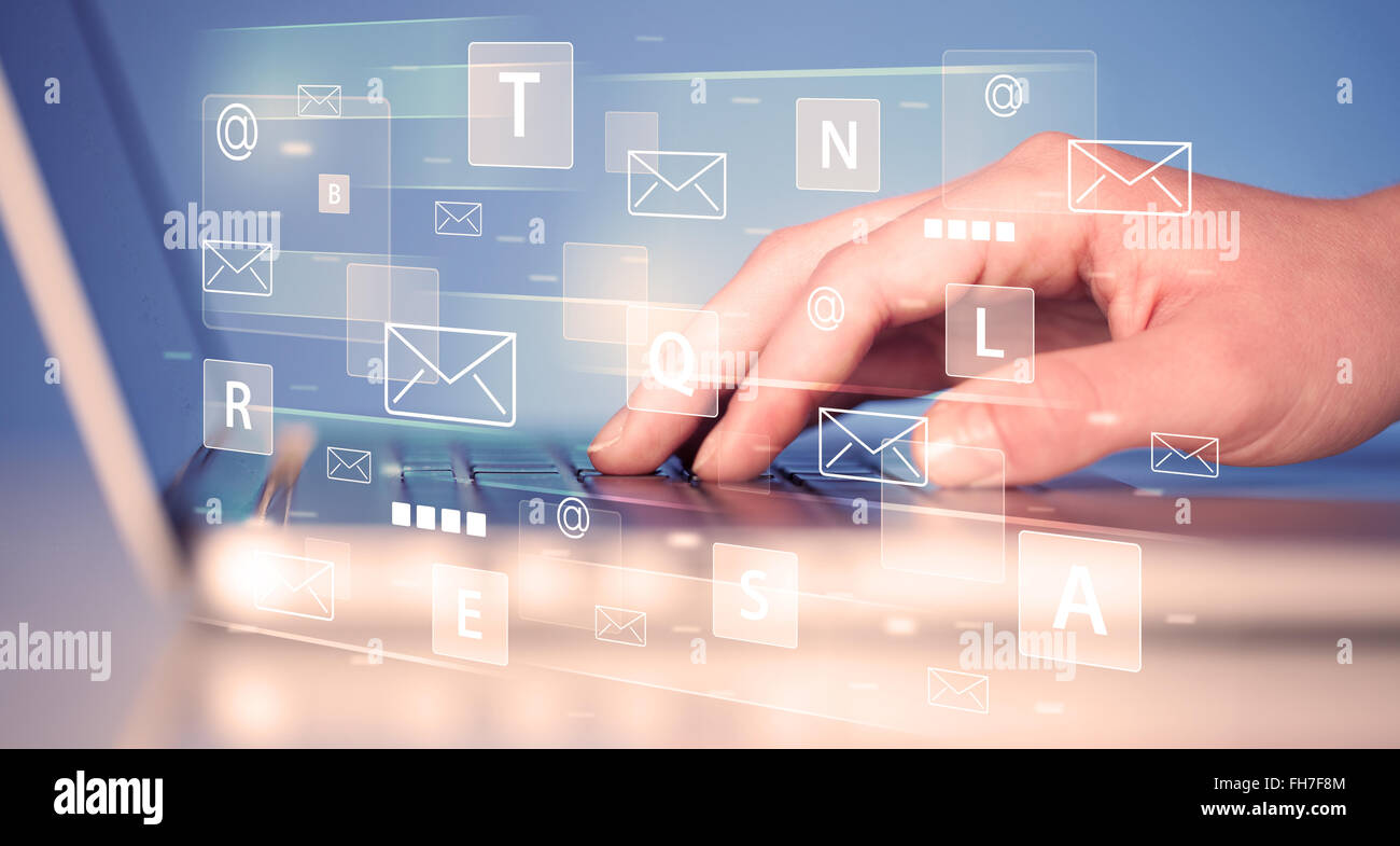 Hand typing on keyboard with digital tech icons Stock Photo - Alamy