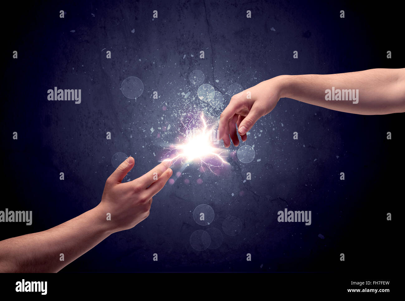 Hands reaching to light a spark Stock Photo - Alamy