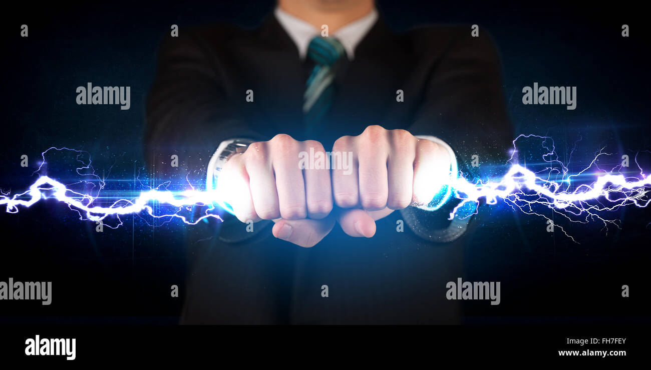 Business man holding electricity light bolt in his hands Stock Photo ...