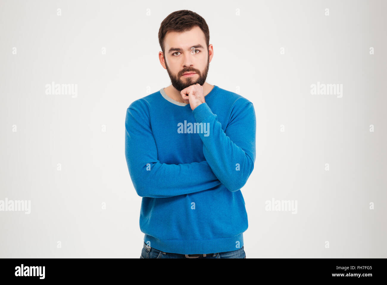 Pensive casual man standing isolated on a white background Stock Photo ...