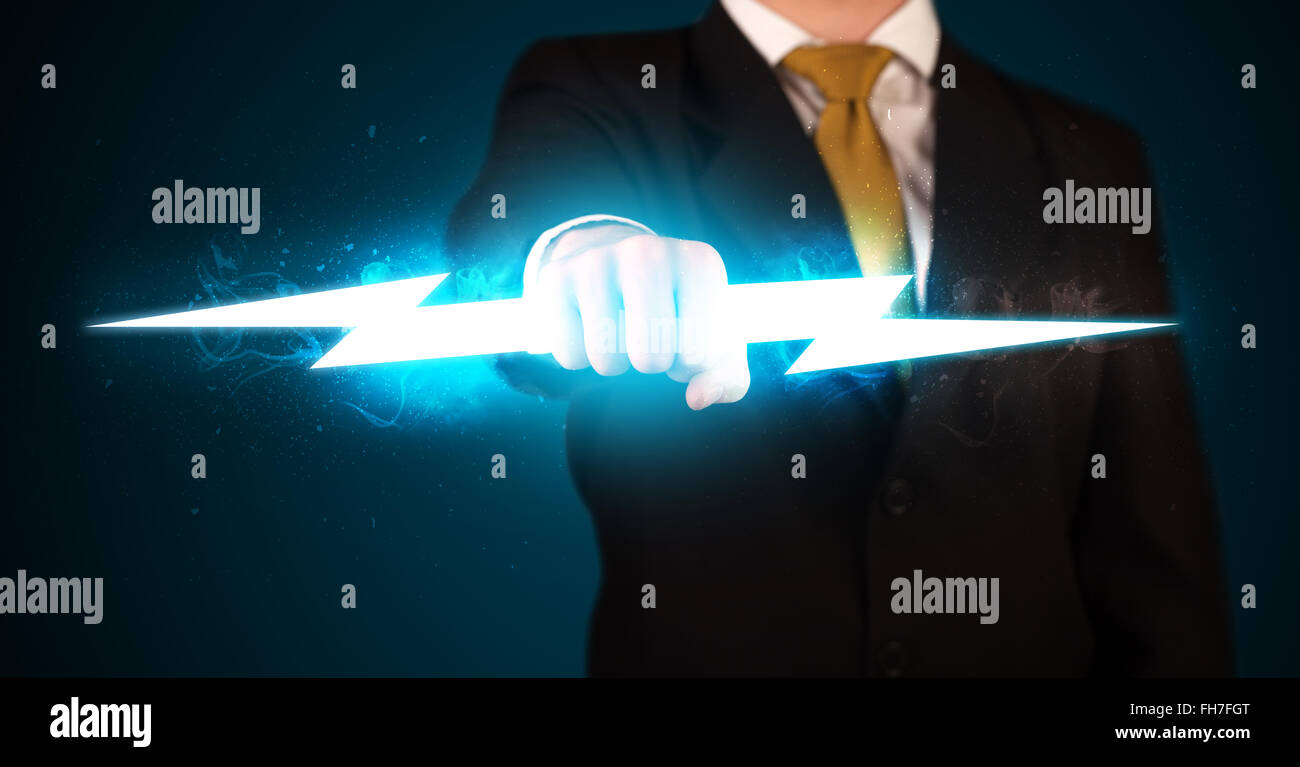Business man holding glowing lightning bolt in his hands Stock Photo ...