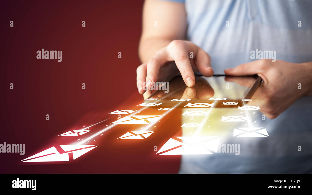Hand holding tablet and sending email icons Stock Photo - Alamy
