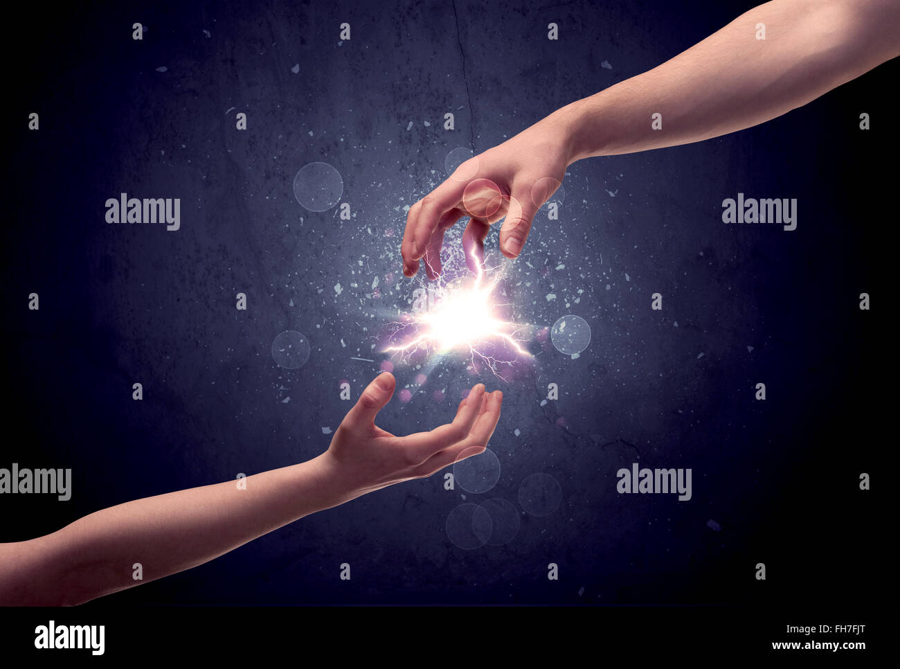Hands reaching to light a spark Stock Photo - Alamy