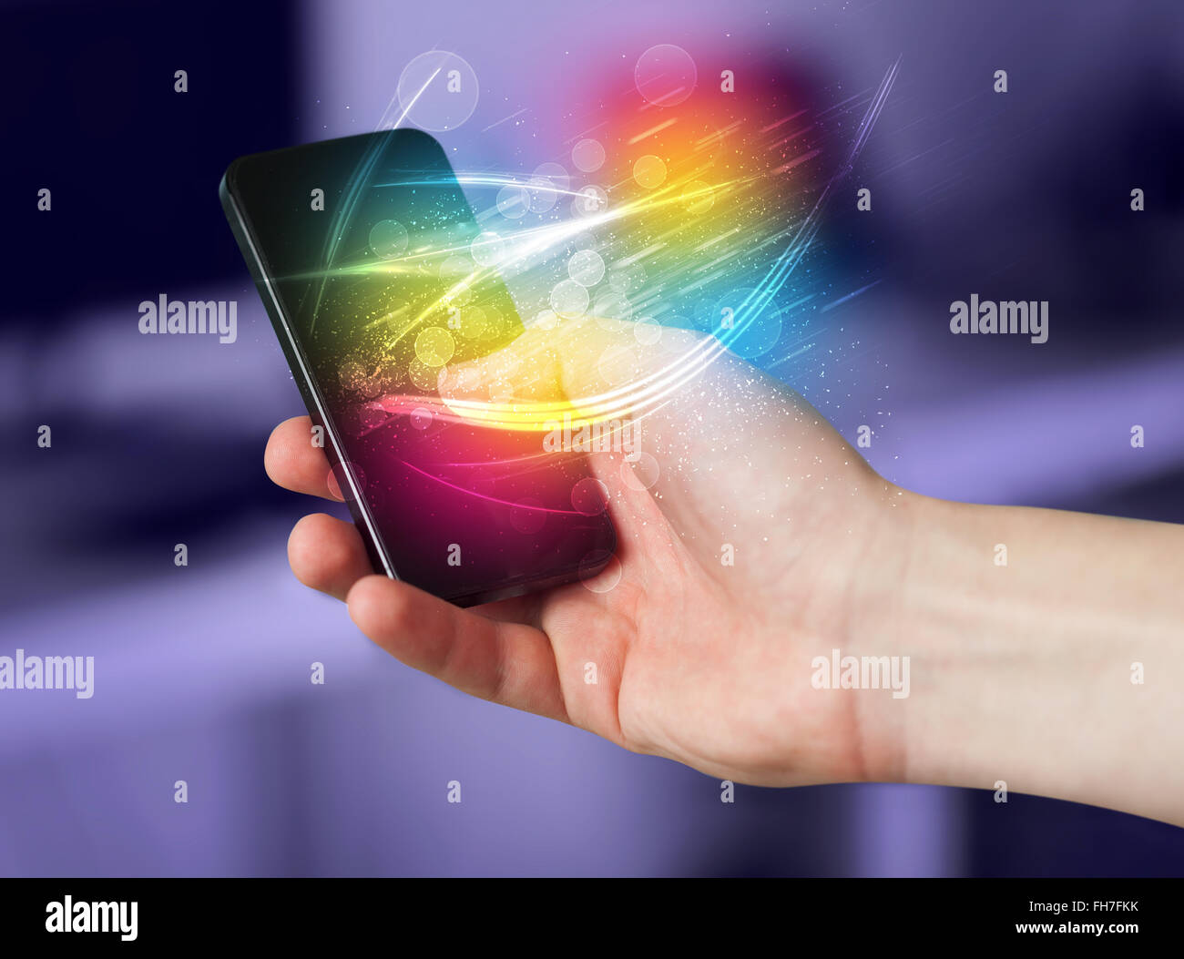Hand holding smart phone with abstract glowing lines Stock Photo - Alamy