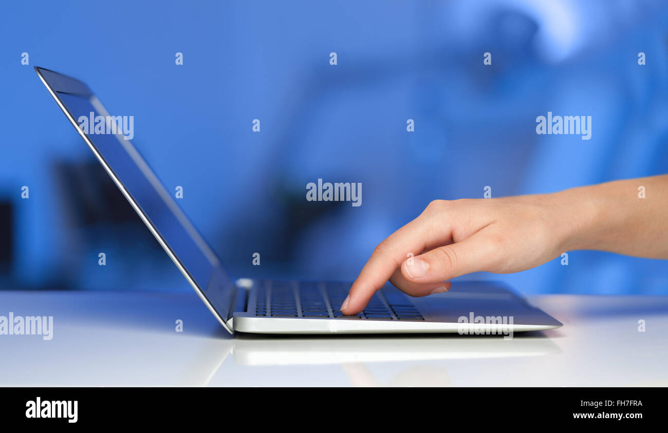 Businessman pressing modern laptop computer on colorful background ...