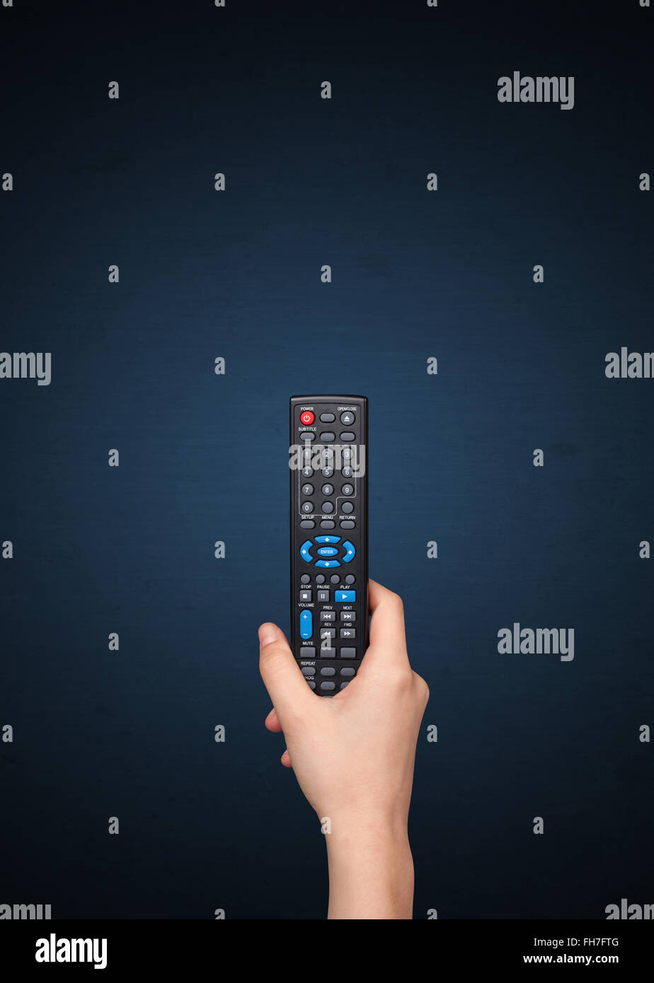 Hand with remote control Stock Photo - Alamy