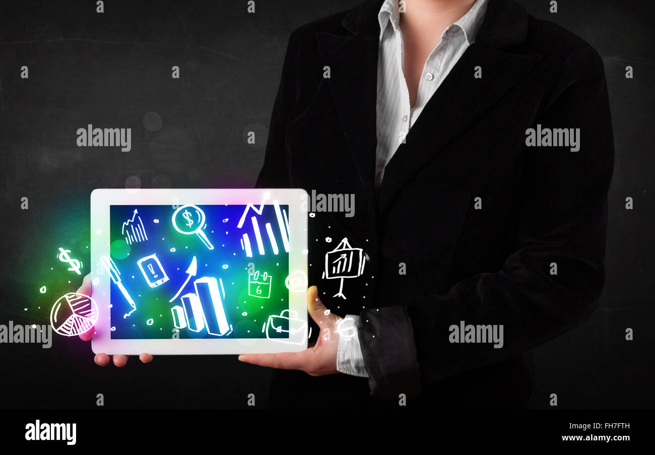 Young person holding tablet with graph and chart symbols Stock Photo ...