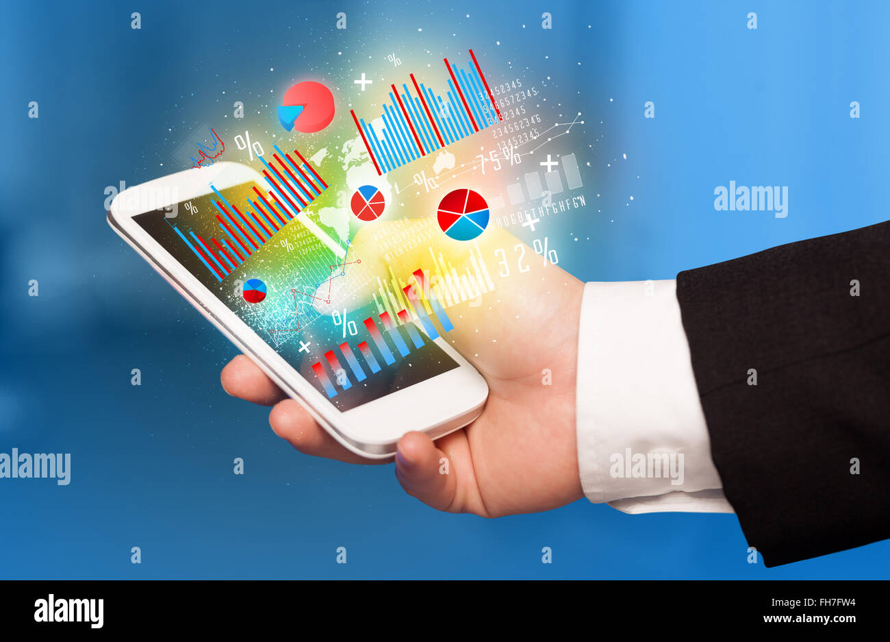 Business man holding smartphone with chart symbols Stock Photo - Alamy