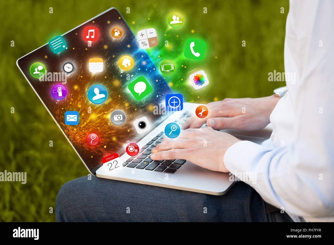 Hand pressing modern laptop with mobile app icons and symbols Stock ...