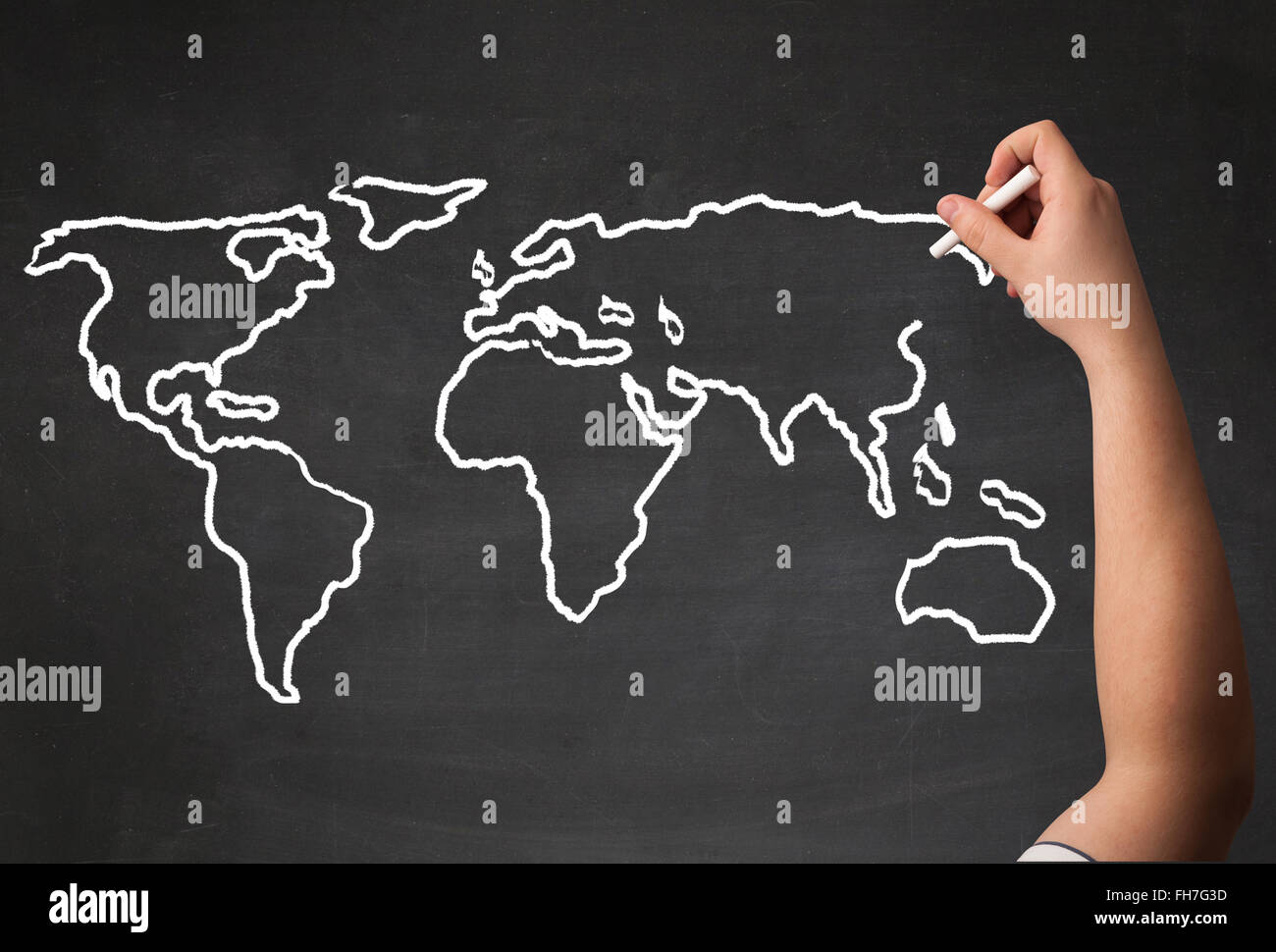 Adult drawing world map on chalkboard Stock Photo - Alamy
