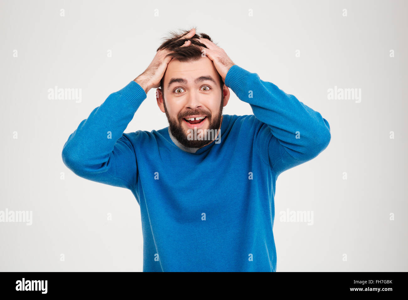 Cheerful amazed man looking at camera isolated on a white background ...