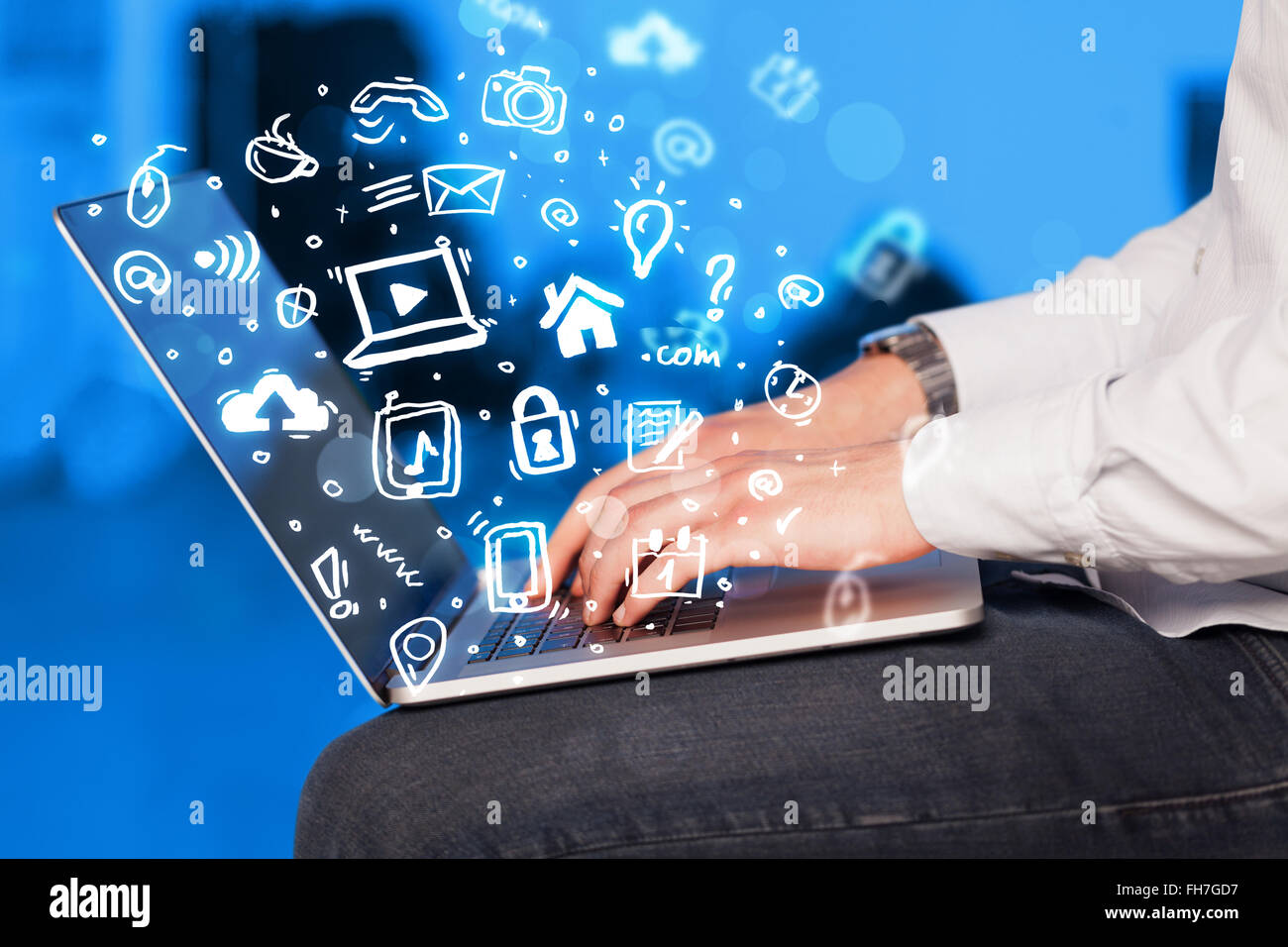 Hand writing on notebook computer with media icons and symbols Stock ...