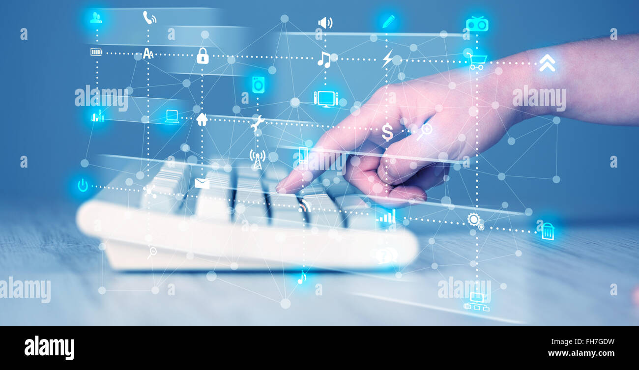 Hand pressing keyboard with high tech media icons Stock Photo - Alamy