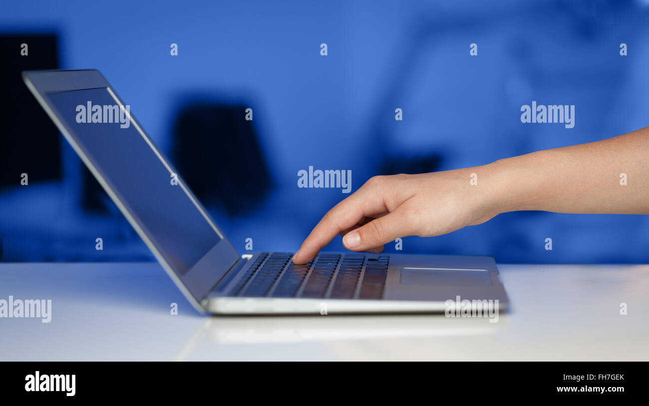 Businessman pressing modern laptop computer on colorful background ...