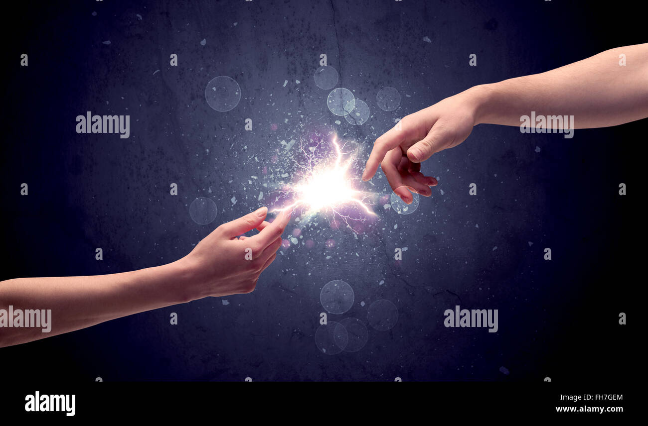 Hands reaching to light a spark Stock Photo - Alamy