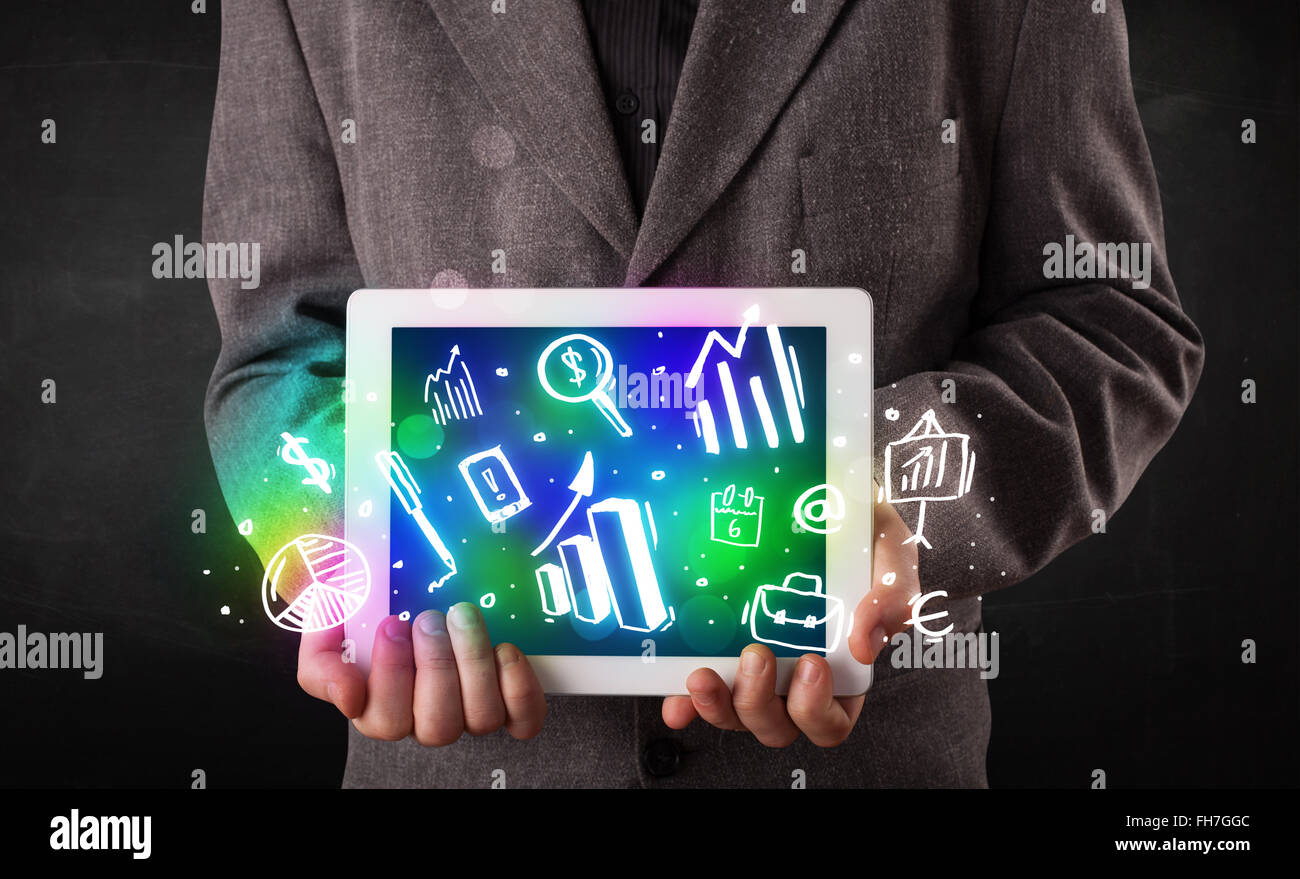 Young person holding tablet with graph and chart symbols Stock Photo ...