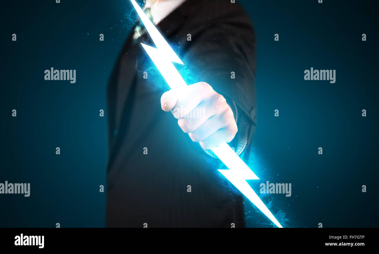 Business man holding glowing lightning bolt in his hands Stock Photo ...