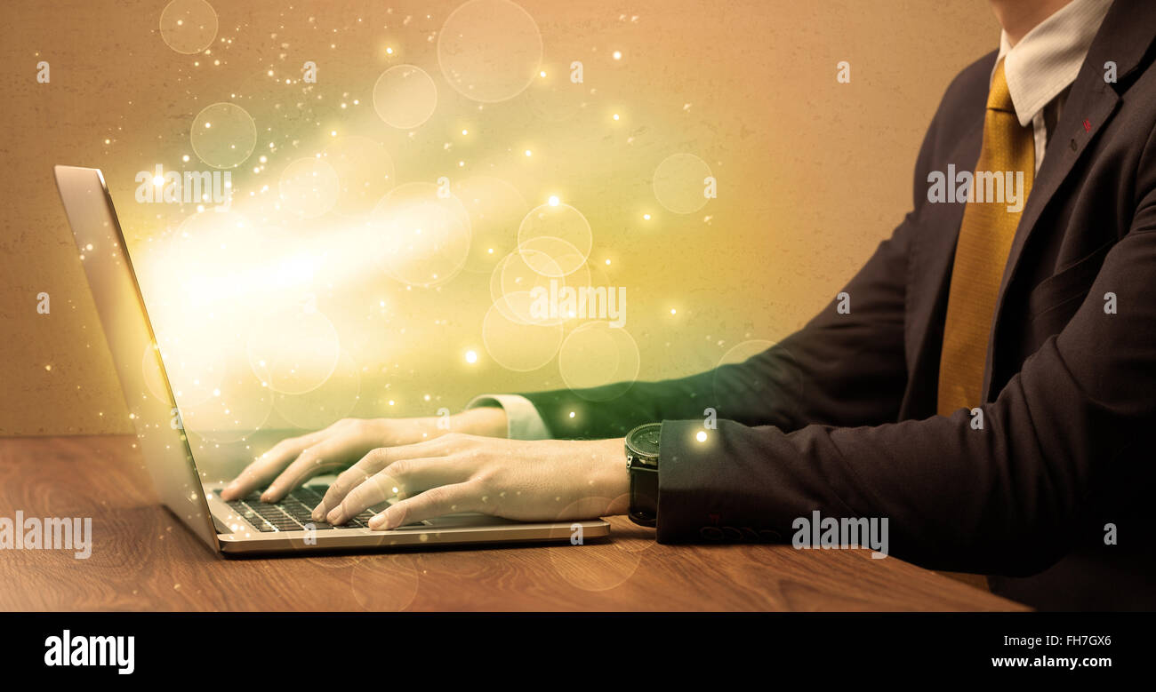 Businessman working fast on laptop Stock Photo - Alamy