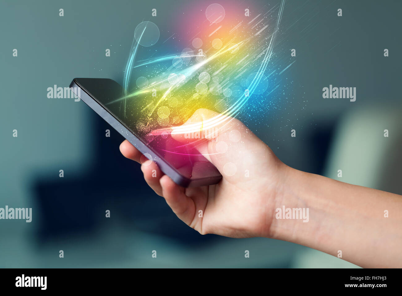 Hand holding smart phone with abstract glowing lines Stock Photo - Alamy
