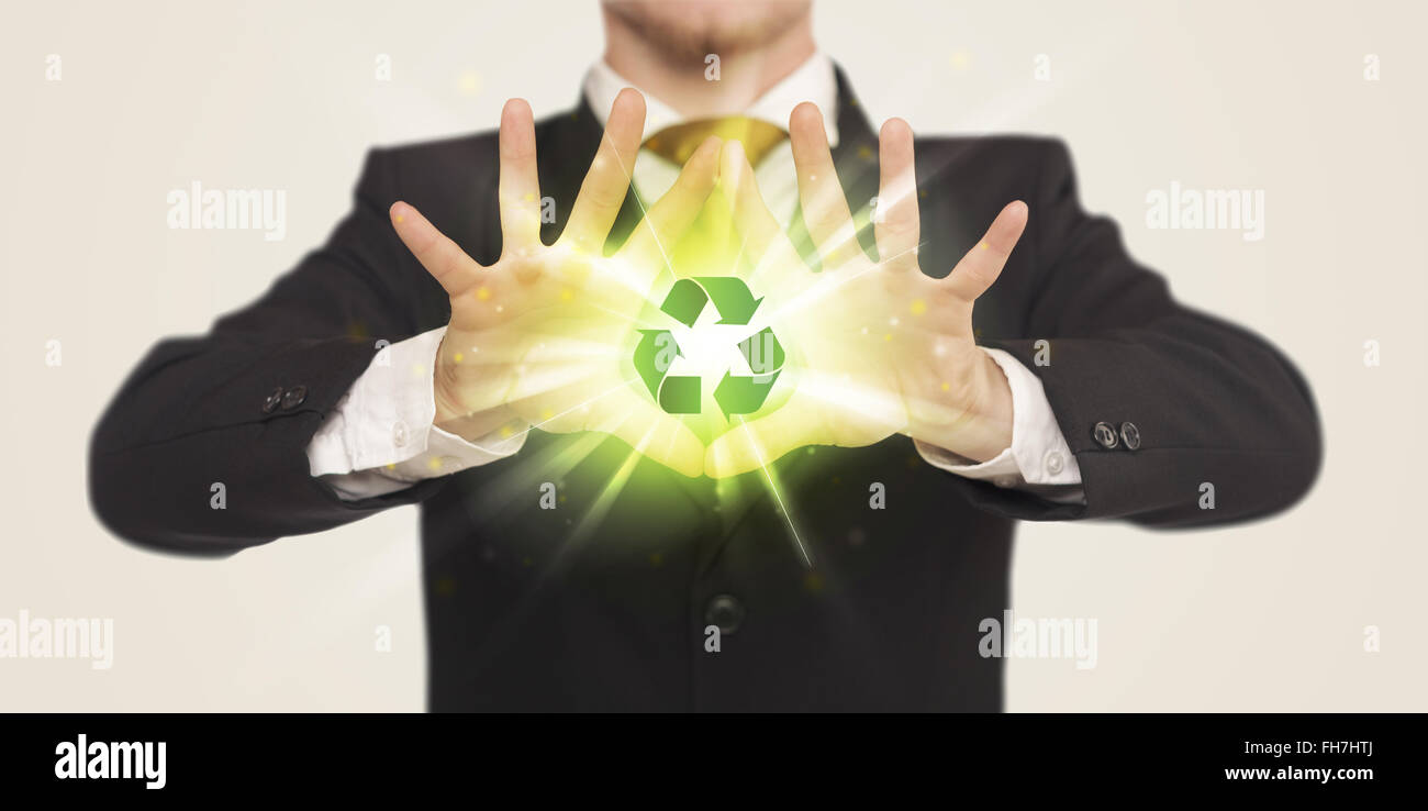Hands creating a form with recycling sign Stock Photo - Alamy