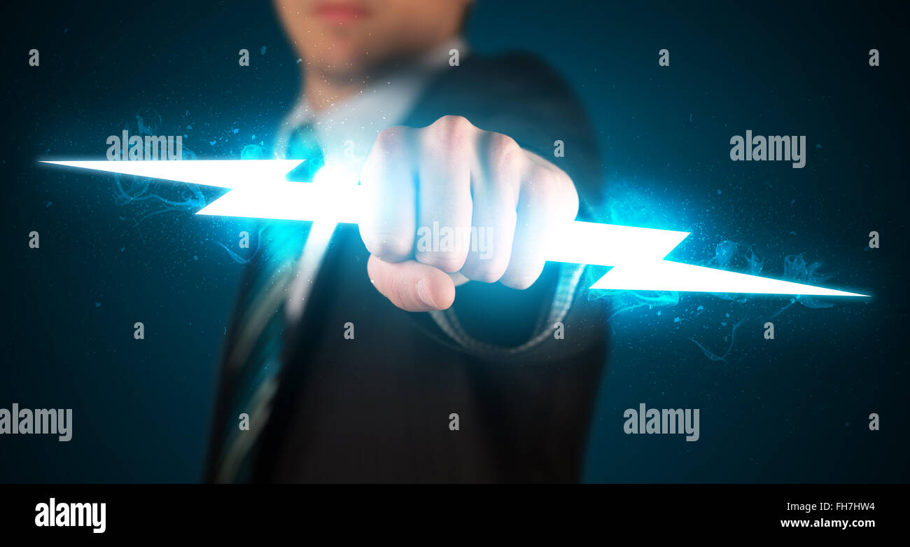 Business man holding glowing lightning bolt in his hands Stock Photo ...